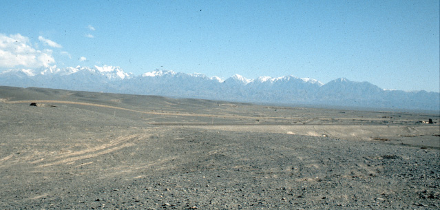 High Pebble Desert Plateau in Tianshan Mountains with snowy peaks in ...